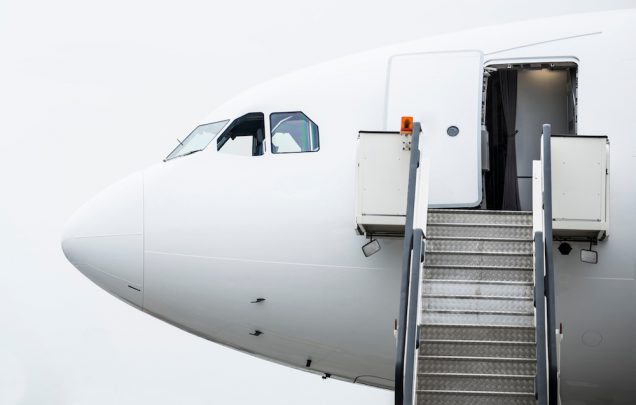 Late passenger arrested after trying to rip the doors off a plane at ...