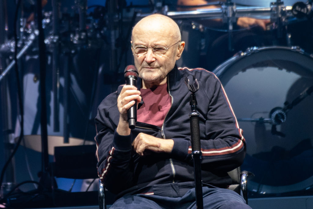Ailing Phil Collins, 70, performs seated in a chair as singer battles ...